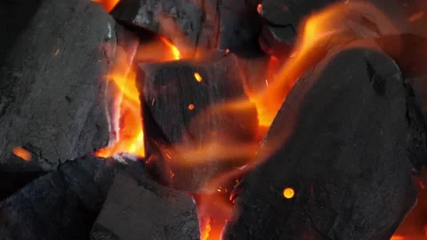 Burning charcoal pile with ash and flake... | Stock Video | Pond5