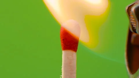 Burning fire match on a green background... | Stock Video | Pond5