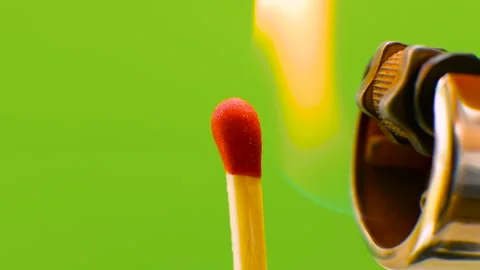 Burning fire match on a green background... | Stock Video | Pond5