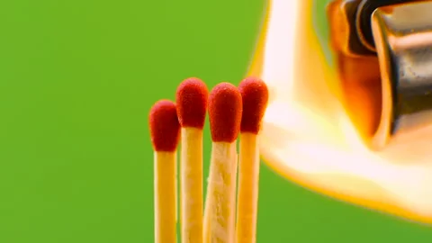 Burning fire match on a green background... | Stock Video | Pond5