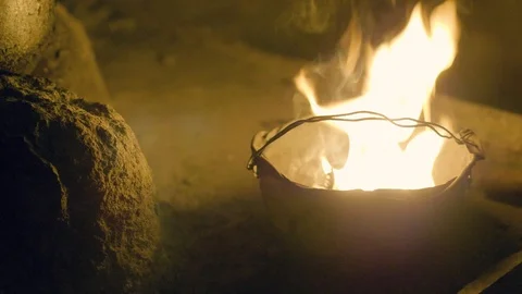 Burning flame fire in bowler pot at dark... | Stock Video | Pond5