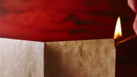 Burning paper on red background | Stock Video | Pond5