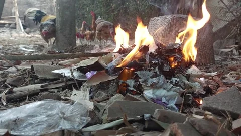 burning plastic waste in the yard in the... | Stock Video | Pond5
