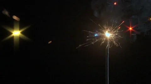 burning sparkler with sparks on a black ... | Stock Video | Pond5