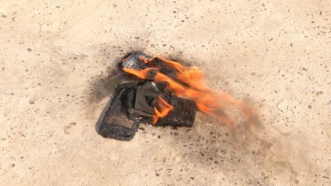 burnt mobile phones on a textural concre... | Stock Video | Pond5