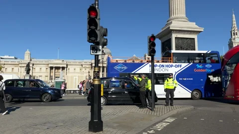 Buses and Police Officers in busy Trafal... | Stock Video | Pond5