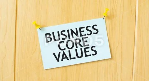 BUSINESS CORE VALUES, sign written on sticky note pinned on wooden wall ...