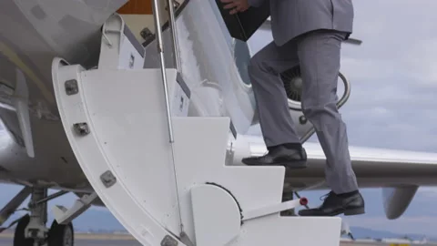 Business Man Steps Onto Jet Plane Stairs | Stock Video | Pond5