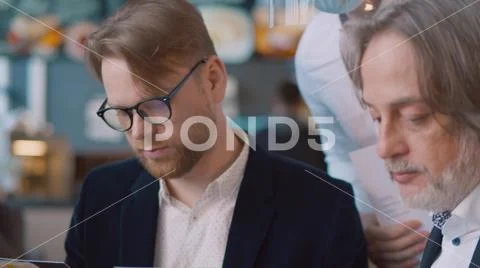 Business people reading menu and ordering in restaurant Stock Photo ...