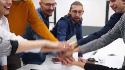 Business people stack hands in pile over... | Stock Video | Pond5
