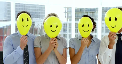 Business team holding smiley face balloo... | Stock Video | Pond5