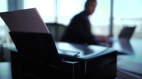 Businessman grabbing paper from printer | Stock Video | Pond5