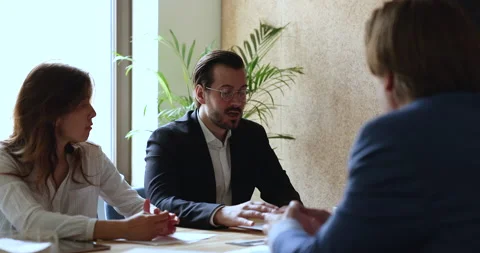 Businessman talk to clients seated at ta... | Stock Video | Pond5