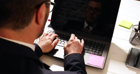 Businessman types on a notebook | Stock Video | Pond5