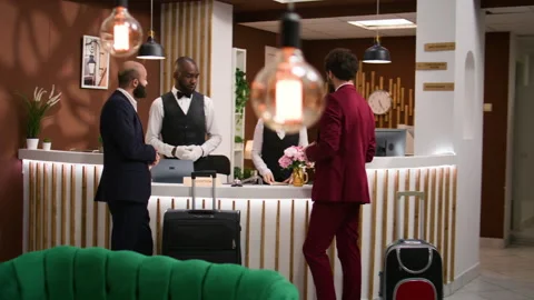 Businessmen start check in formalities | Stock Video | Pond5