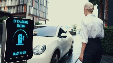 Businesswoman pull out EV charger from c... | Stock Video | Pond5
