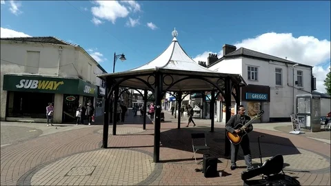 Busker under a pavilion in small town hi... | Stock Video | Pond5