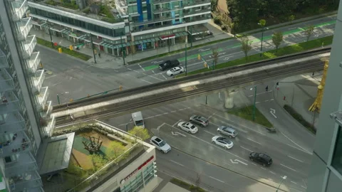 Busy intersection as the SkyTrain passes... | Stock Video | Pond5