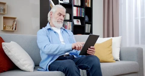 Busy old man swiping, scrolling on table... | Stock Video | Pond5