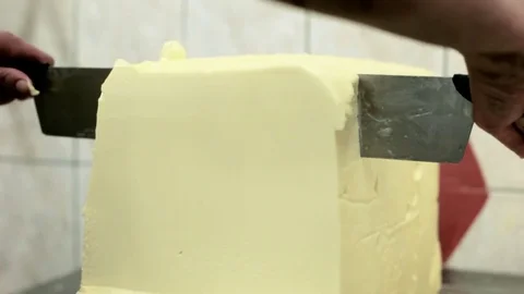 Butter block cutting. Big stick of butte... | Stock Video | Pond5