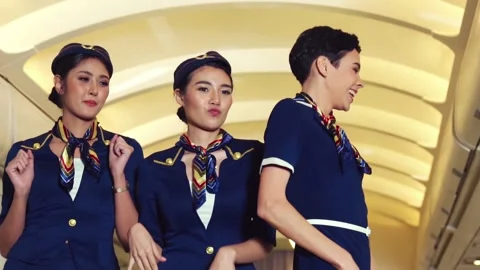 Cabin crew dancing with joy in airplane | Stock Video | Pond5
