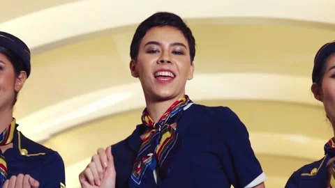 Cabin crew dancing with joy in airplane | Stock Video | Pond5
