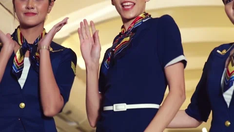 Cabin crew dancing with joy in airplane | Stock Video | Pond5