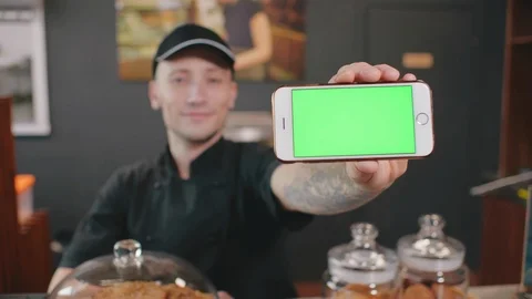 Cafe waiter holding green screen tablet ... | Stock Video | Pond5