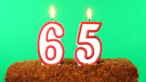 Cake with the number 65 lighted candle. ... | Stock Video | Pond5