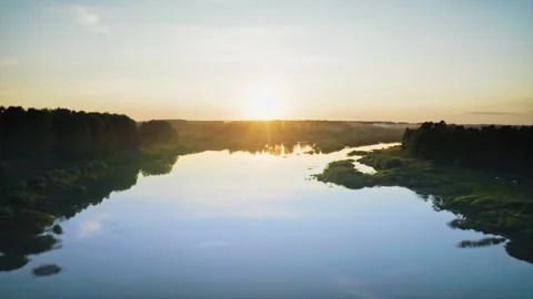 A calm mirror of water reflecting the bl... | Stock Video | Pond5