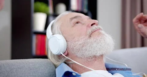 Calm older man sitting on sofa in living... | Stock Video | Pond5