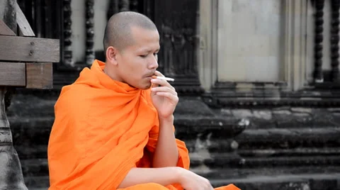 cambodian monk smoking in angkor wat tem... | Stock Video | Pond5