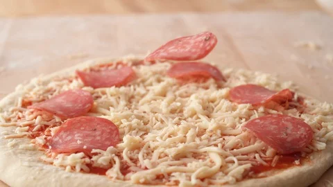 Camera follows putting a pepperoni on a ... | Stock Video | Pond5
