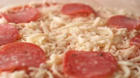 Camera follows putting pepperoni on a pi... | Stock Video | Pond5