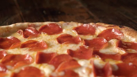 Camera follows a whole pizza with pepper... | Stock Video | Pond5