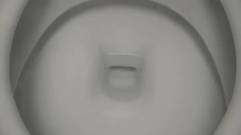 The camera looks into the toilet while t... | Stock Video | Pond5