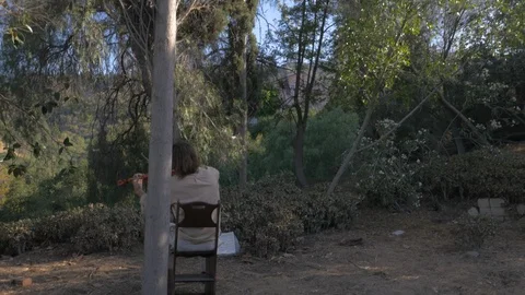 Camera zooming into man sitting on chair... | Stock Video | Pond5