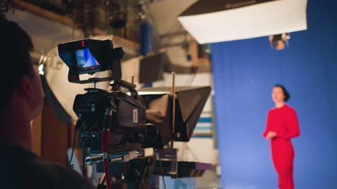 Cameraman Filming Presenter on Blue Scre... | Stock Video | Pond5