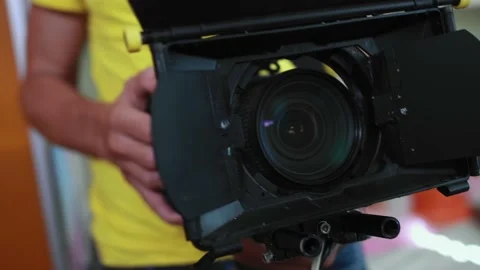 Cameraman operator holds cinema camera i... | Stock Video | Pond5