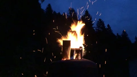 campfire in a fire barrel at night | Stock Video | Pond5