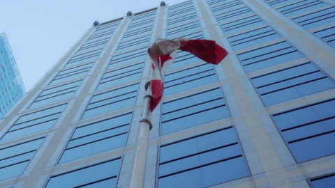 Canadian flag waving in front of the gla... | Stock Video | Pond5