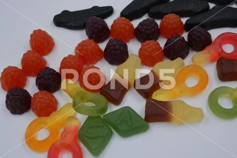Candies in form of black car, raspberries, blackberries, bottles ...