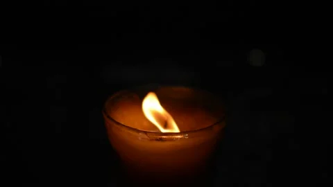 candle burning with red fire flame in th... | Stock Video | Pond5
