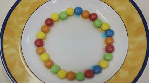 Candy experiment in water creating a flo... | Stock Video | Pond5