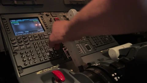 Captain handling the FMS computer inside... | Stock Video | Pond5
