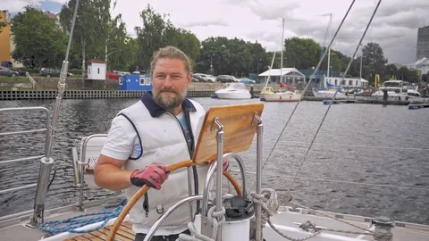 Captain on a yacht behind steering wheel | Stock Video | Pond5