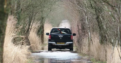A car driving along a flooded causeway t... | Stock Video | Pond5