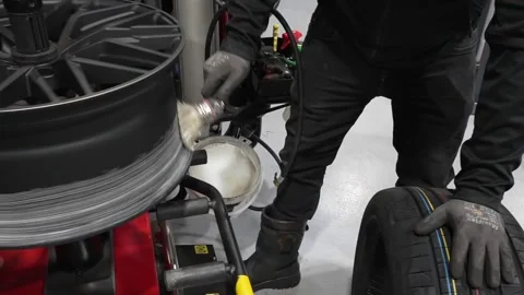 Car mechanic putting tire mounting liqui... | Stock Video | Pond5