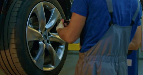 Mechanic Replacing Wheel Car Mechanic Replacing Wheel Car Stock Footage ...