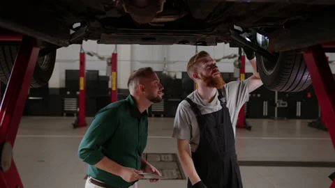 The car mechanic shows the manager what ... | Stock Video | Pond5